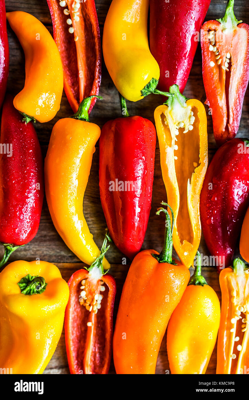 Colorful peppers on rustic background Stock Photo - Alamy
