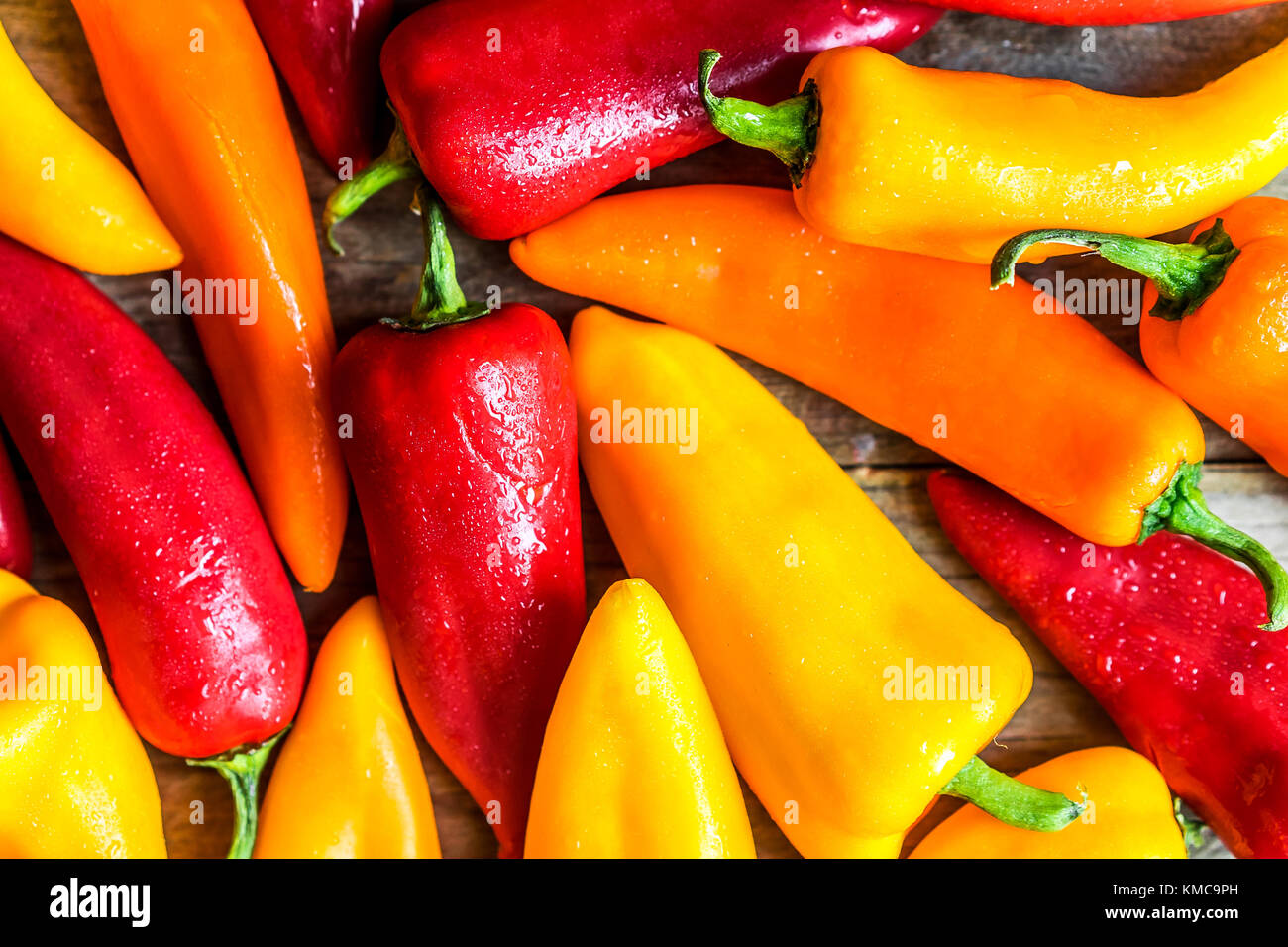Colorful peppers on rustic background Stock Photo - Alamy