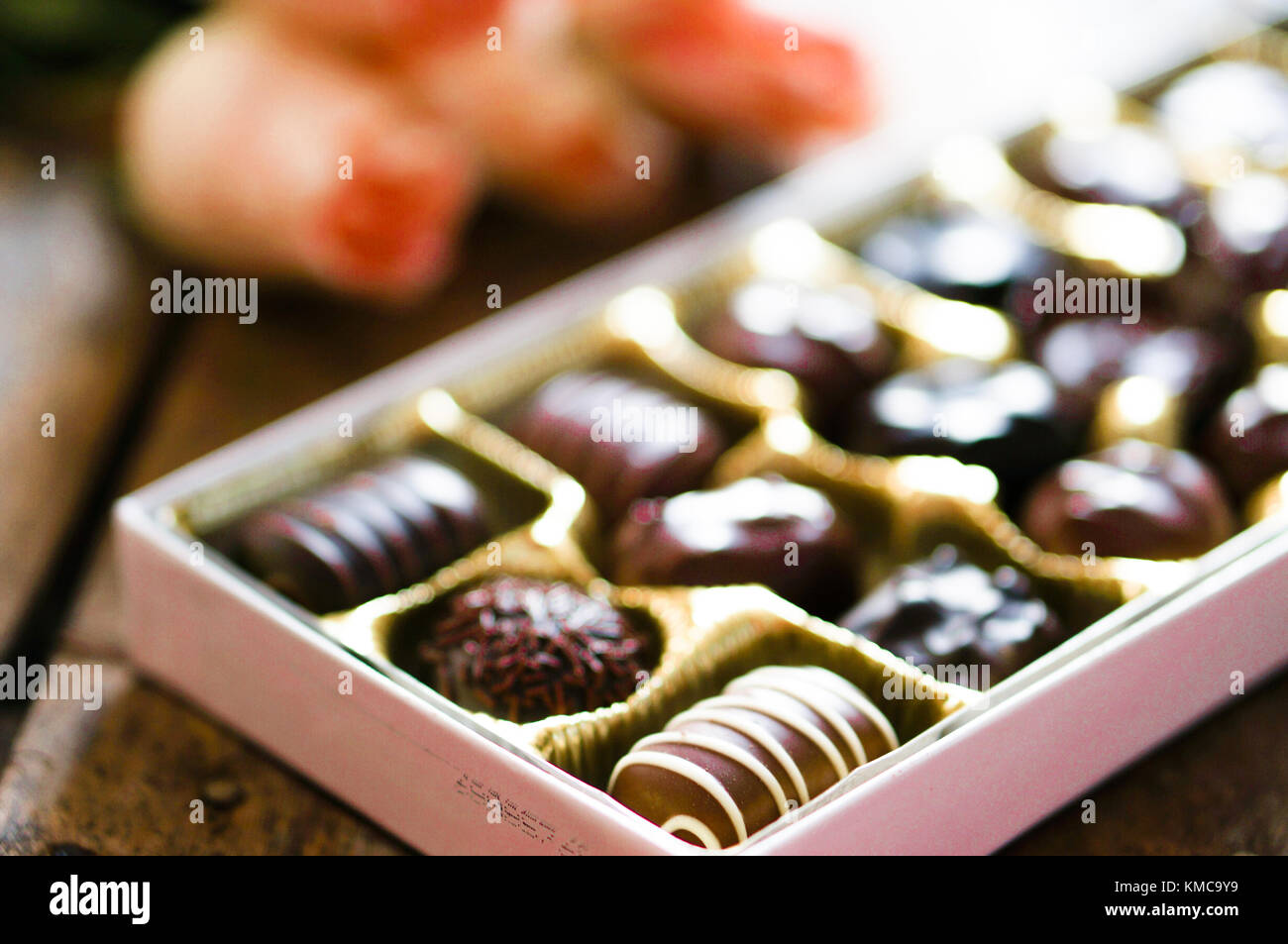 Delicious Chocolate Candies With A Bouquet Of Roses Stock Photo - Alamy