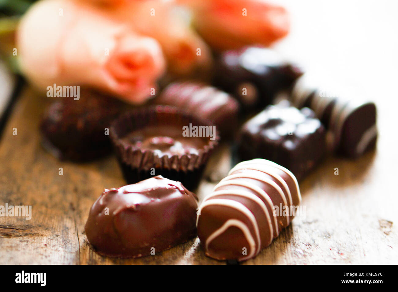 Delicious Chocolate Candies With A Bouquet Of Roses Stock Photo - Alamy