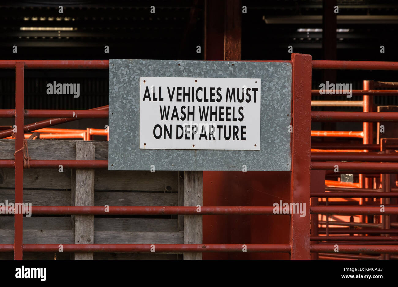 Ambiguously worded sign All Vehicles Must Wash Wheels On Departure ...