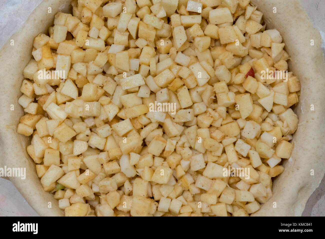 Apples cut into cubes for pie Stock Photo - Alamy