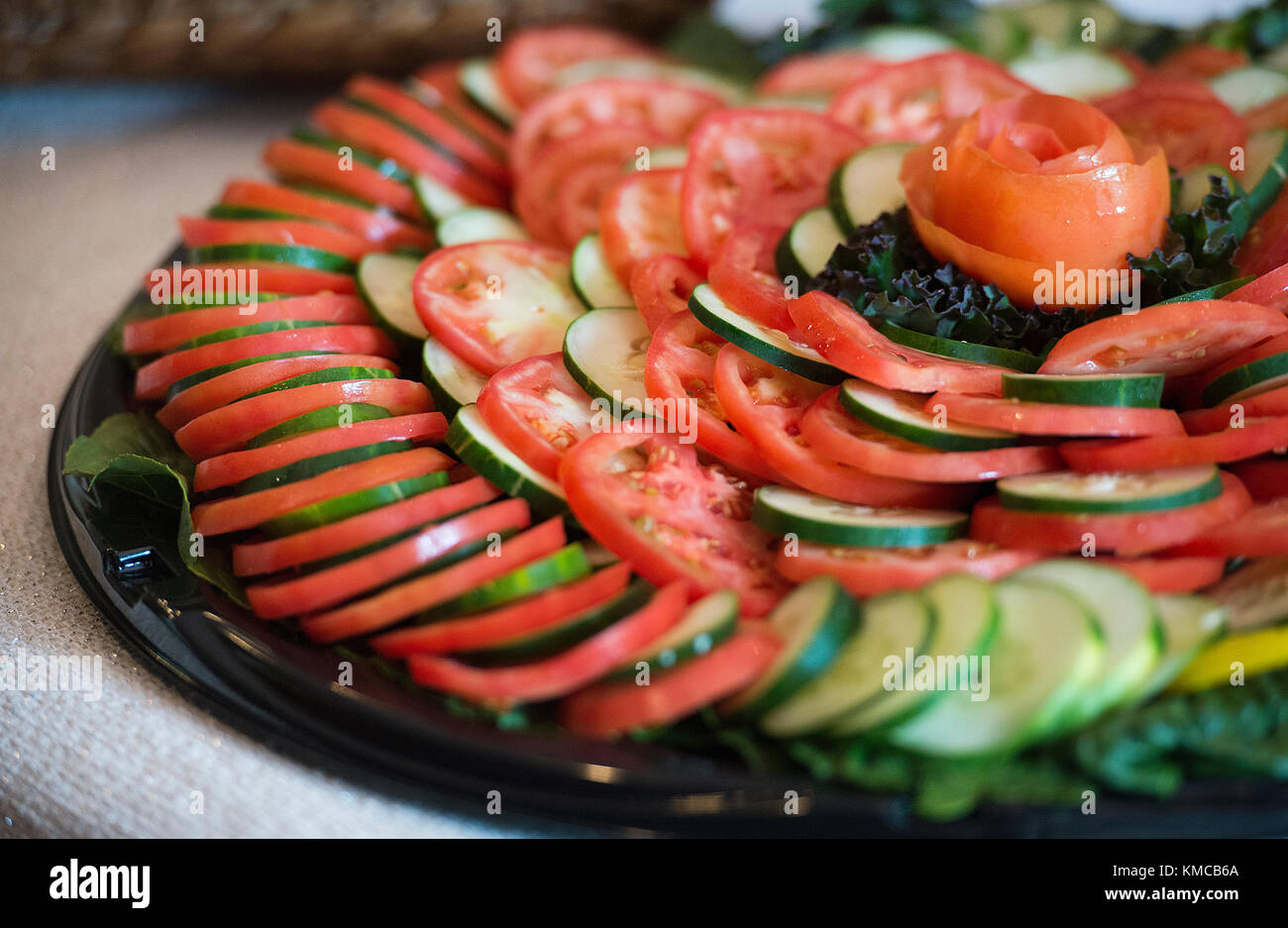 A tray of tomatoes and cucumbers is shown during a party Stock Photo ...