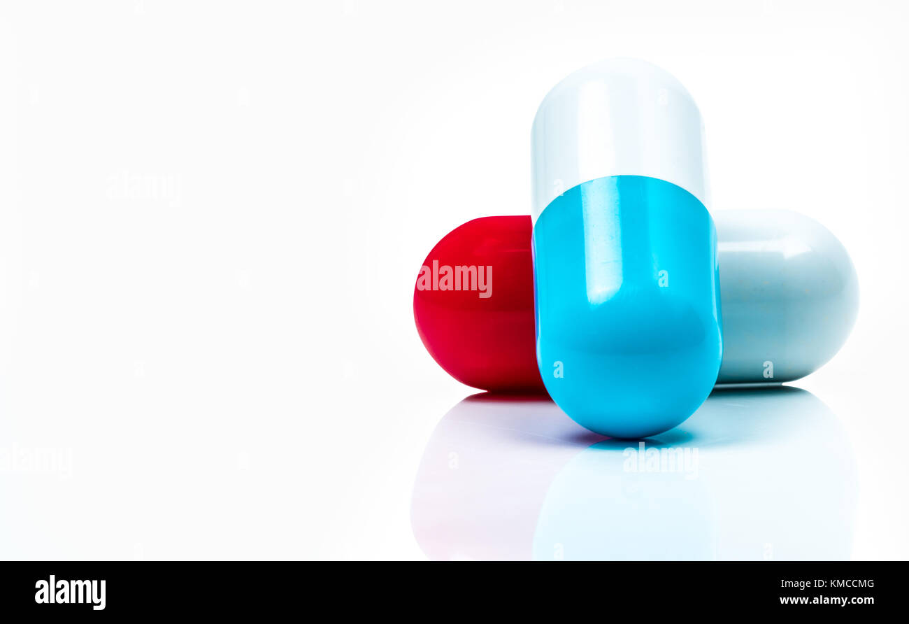 Two capsule pills isolated on white background. Global healthcare ...