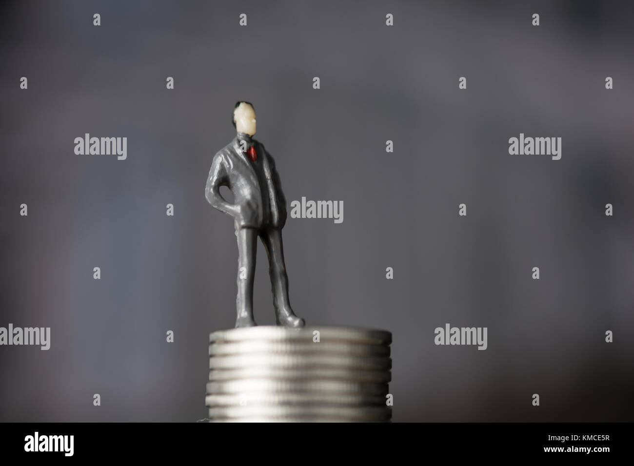 Figure miniature businessman of small people standing on the top stack ...