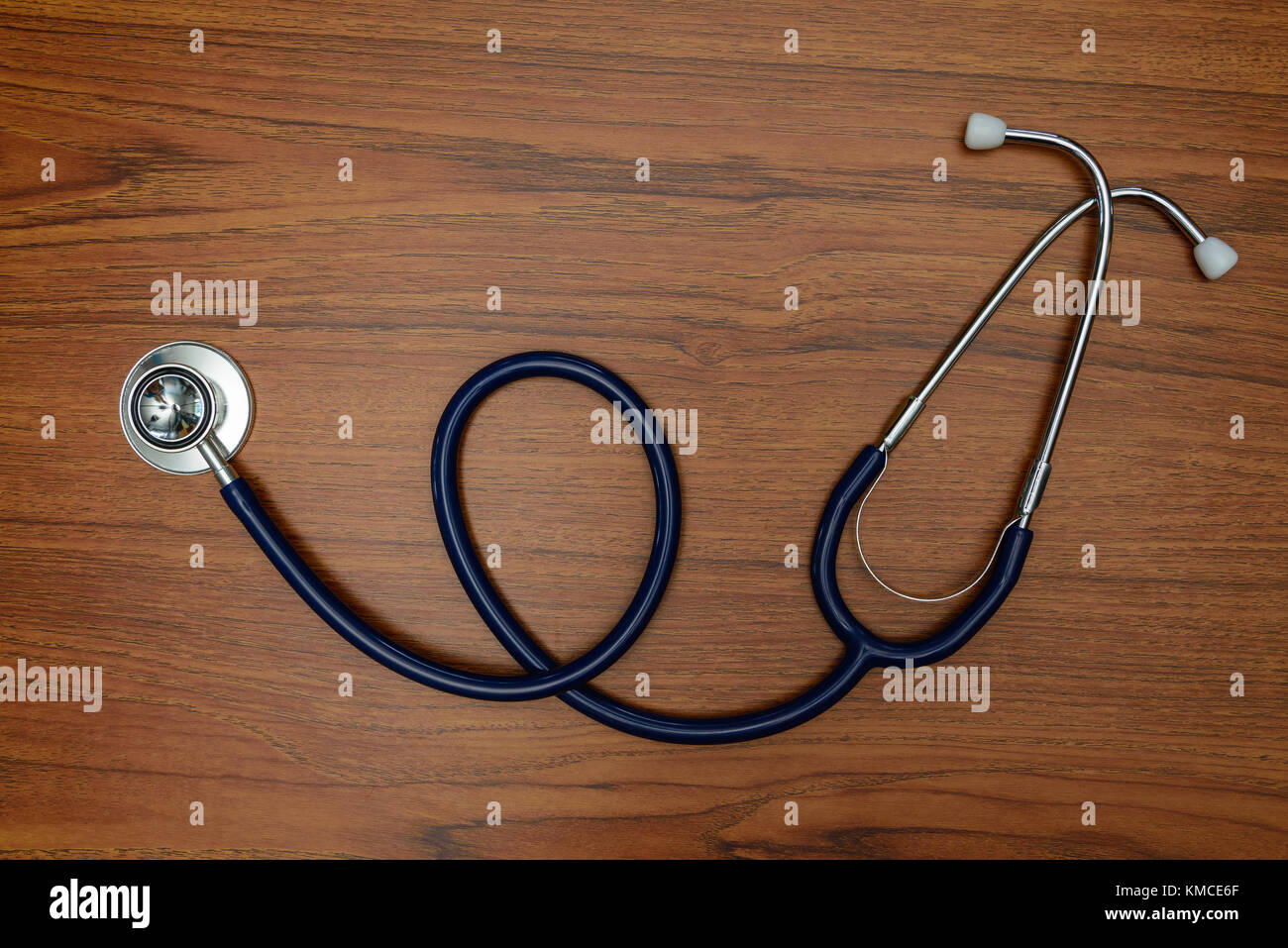 Stethoscope with blue tube on bright wood table top view with copy ...