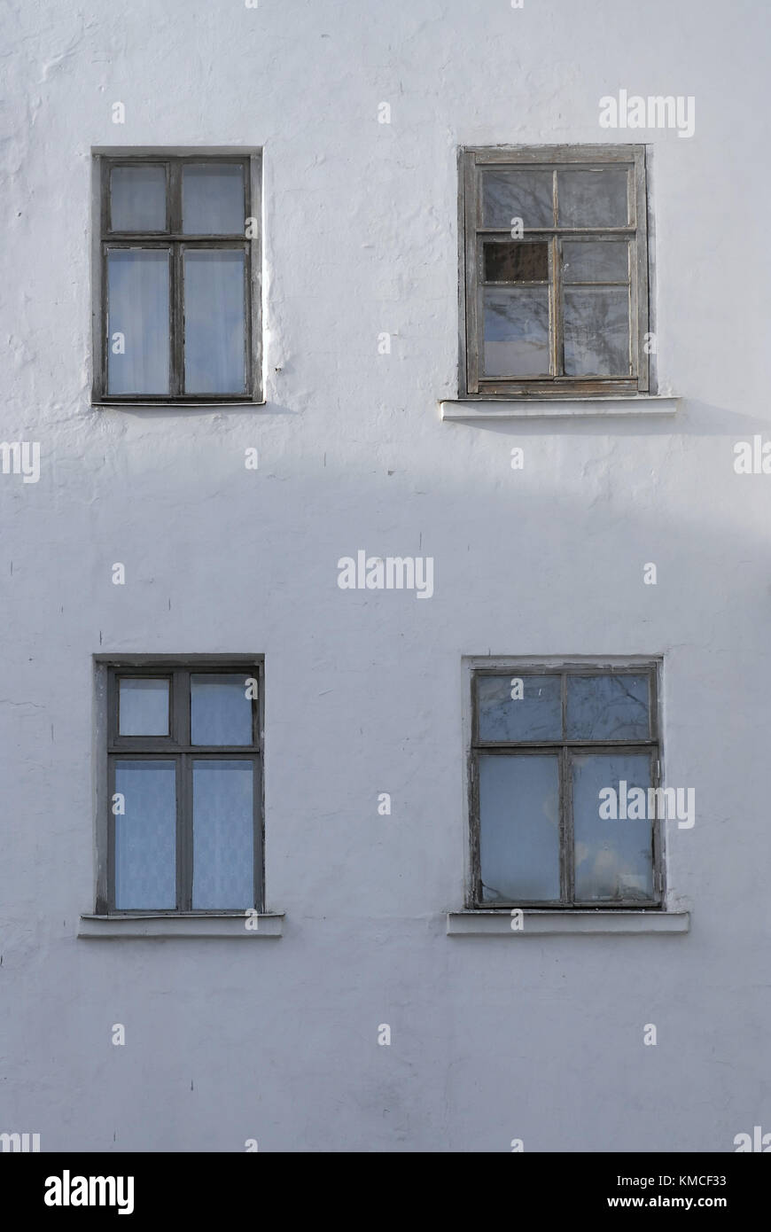 Old house: a white clean wall with four windows with wooden brown ...