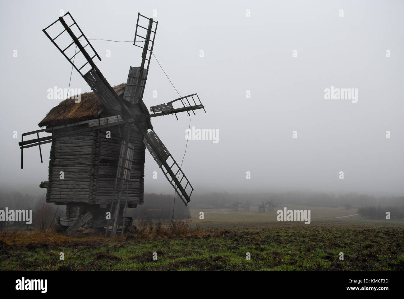 Windmill: old huge structure with blades in the middle of the field ...