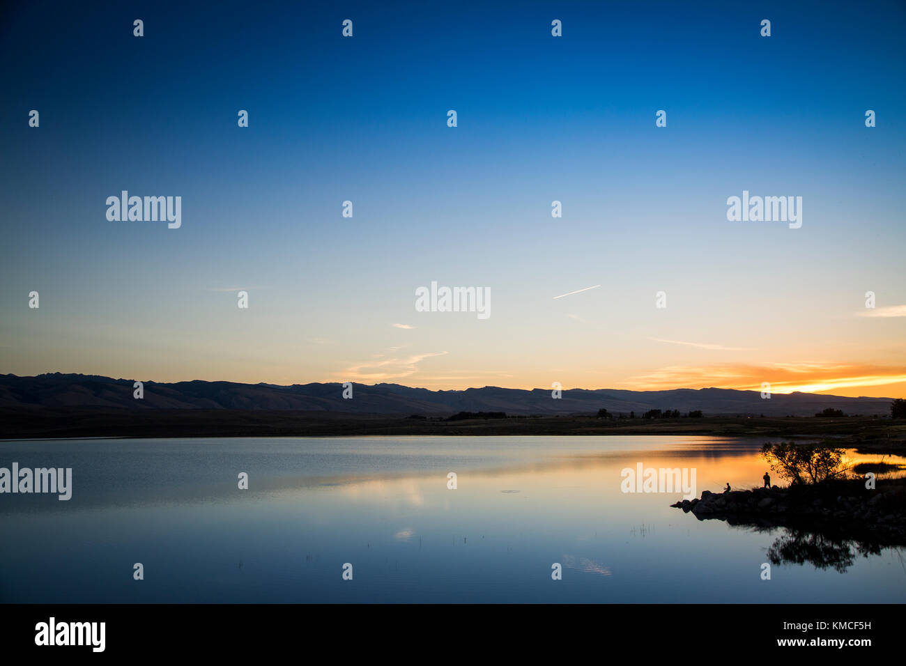 A boy and his father fish on Ray Lake, Wind River Indian Reservation ...