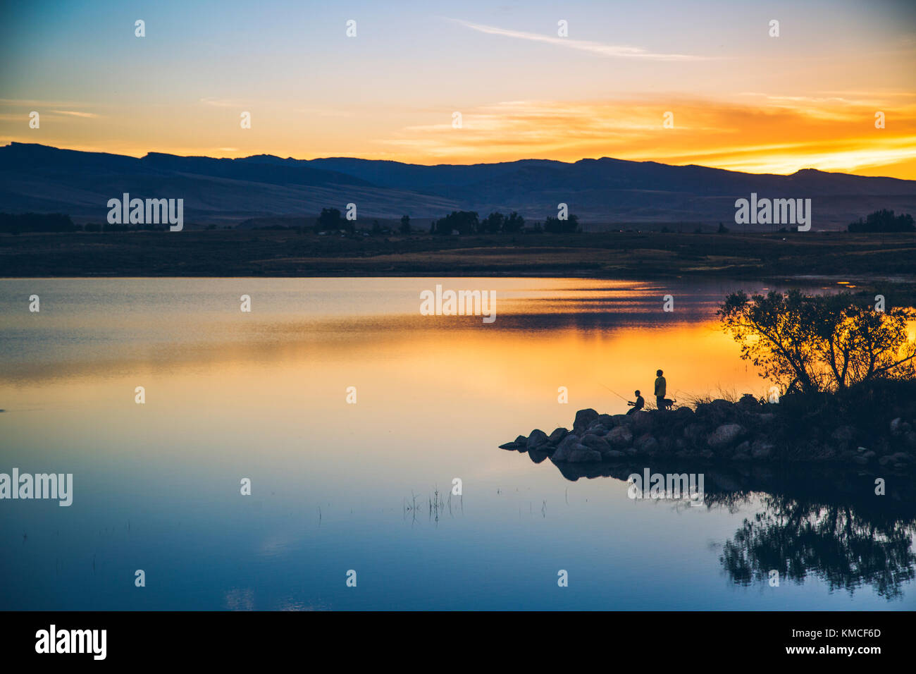 A boy and his father fish on Ray Lake, Wind River Indian Reservation ...