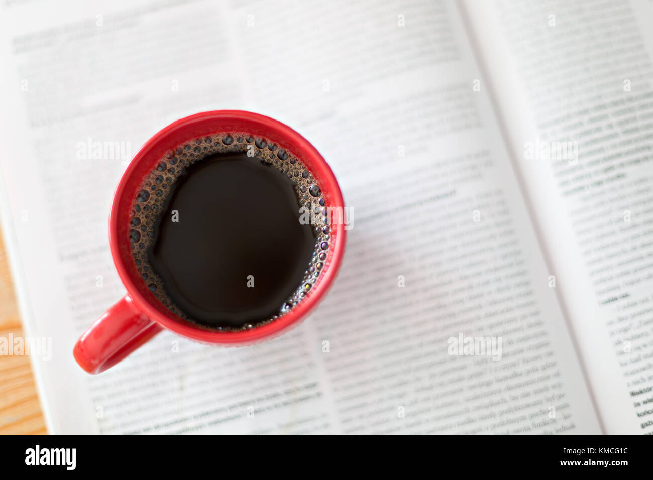 Coffee in red cup and the newspaper Stock Photo - Alamy