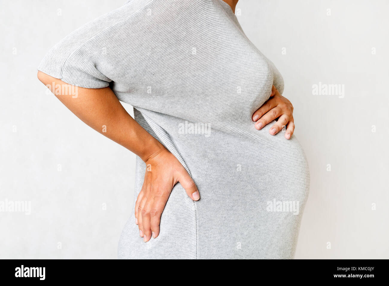 Pregnant woman with stomach pain or back aches, concept of aches in ...