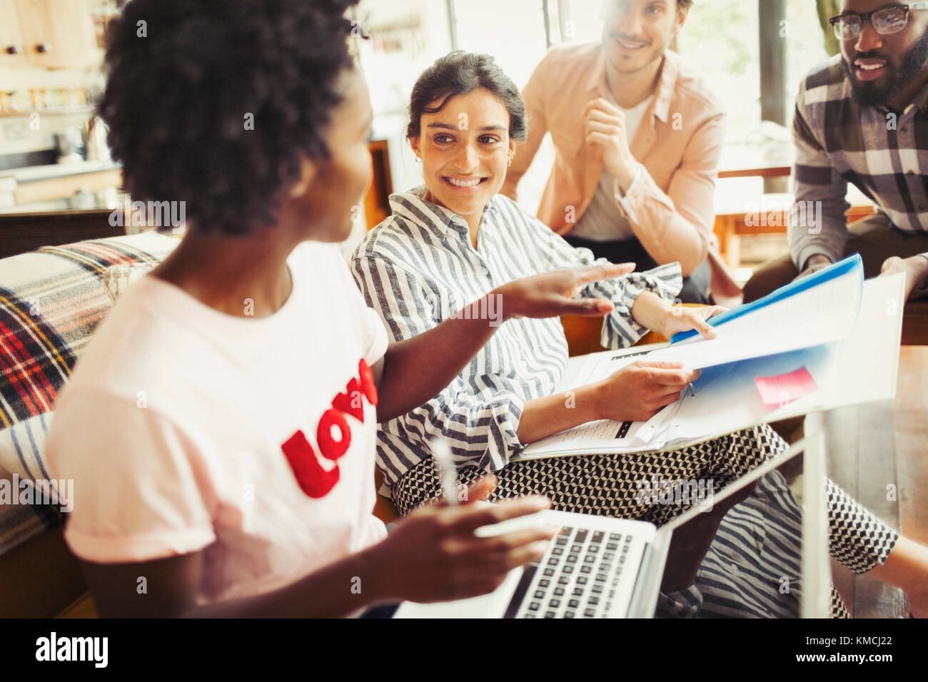 Creative business people meeting, discussing paperwork Stock Photo - Alamy