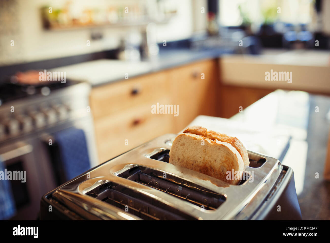 Toast in toaster in kitchen Stock Photo - Alamy