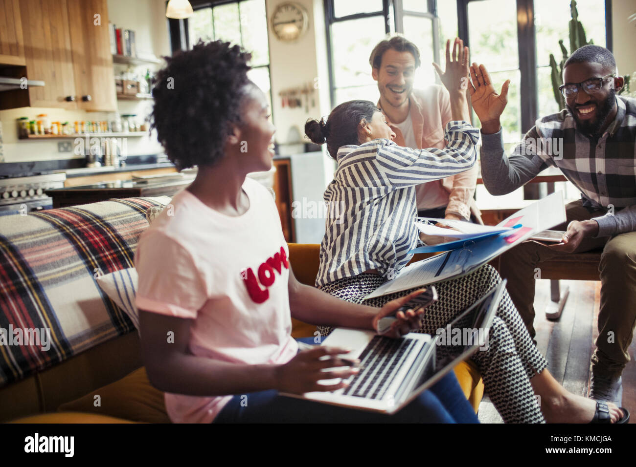 Creative business people high-fiving in meeting Stock Photo - Alamy