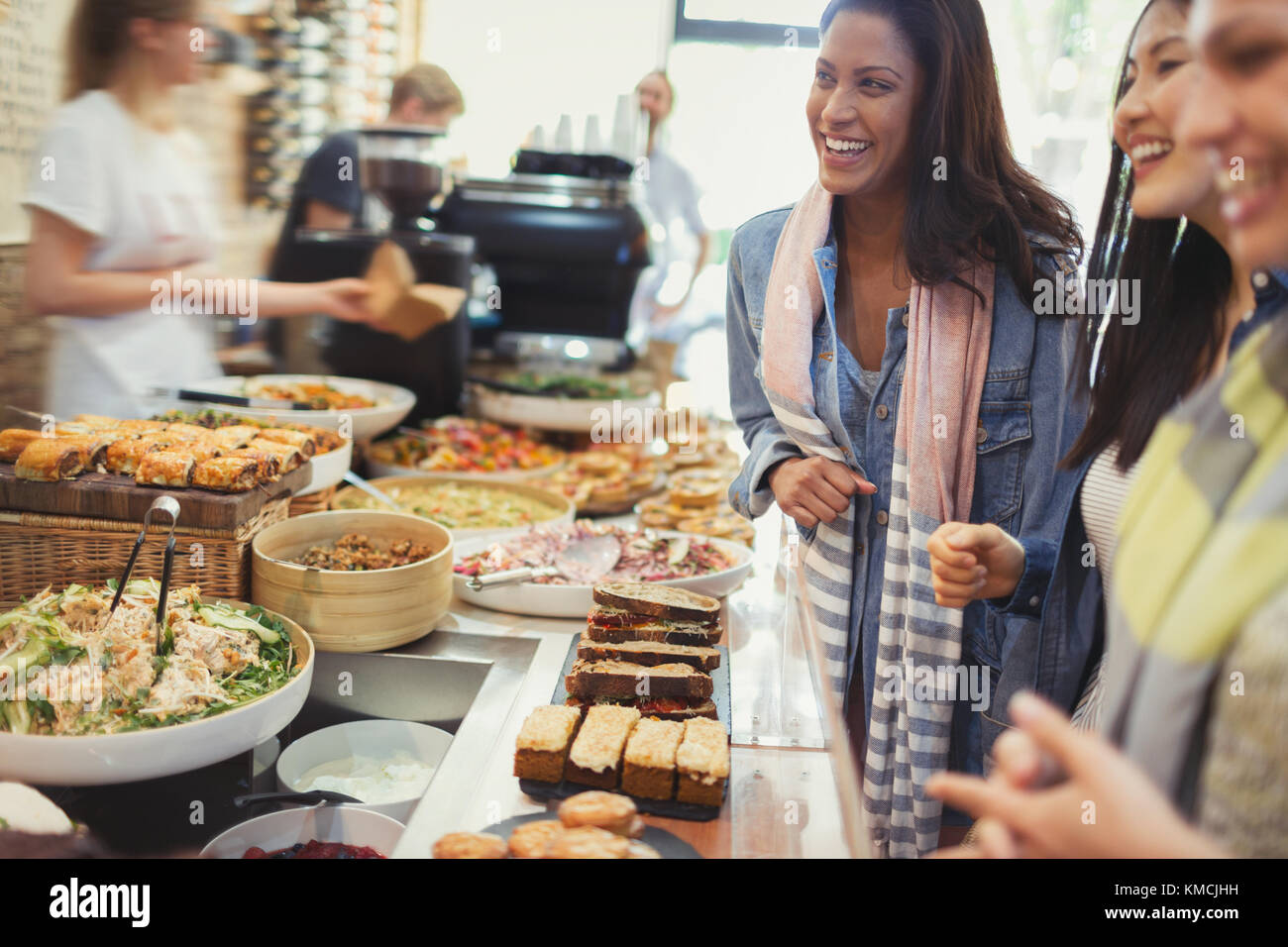 Smiling women friends at cafe Stock Photo - Alamy