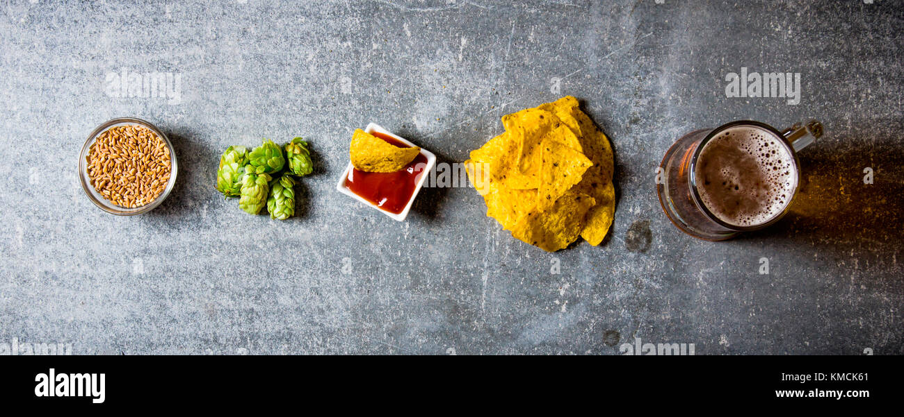 Beer set in an old stone surface. In the set -beer, chips, ketchup ...