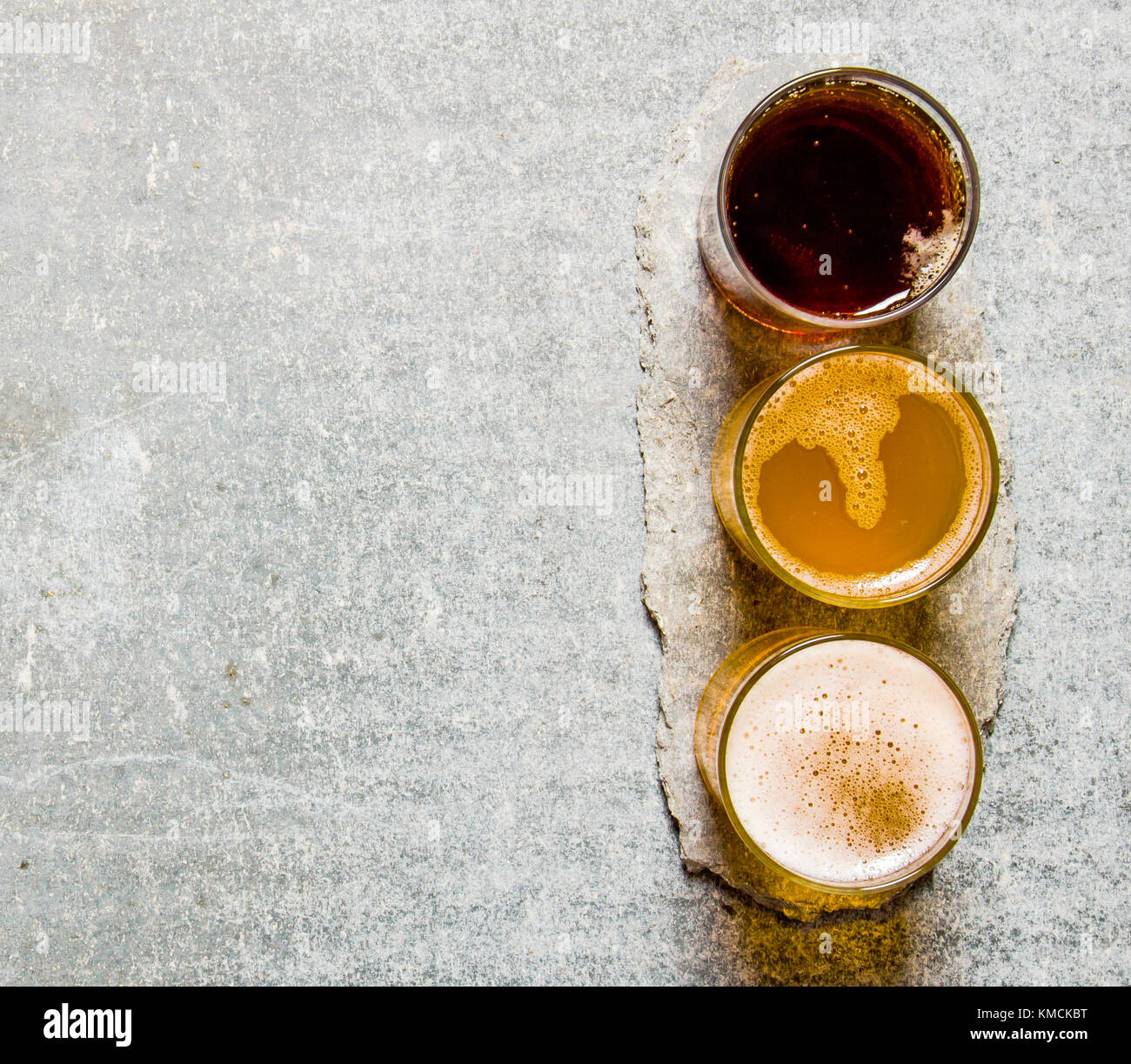 Three beers on a stone pedestal. Free space for text. Top view Stock ...
