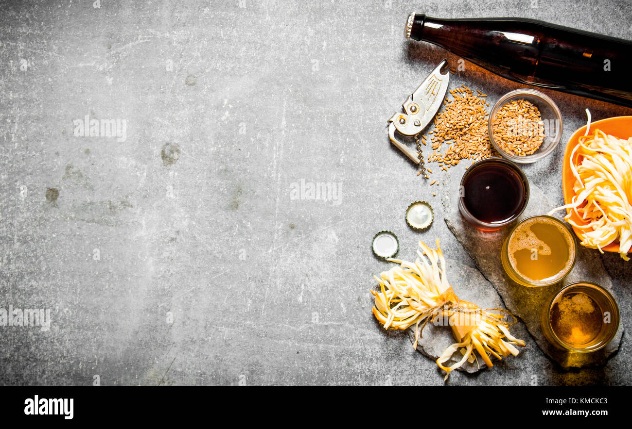 Three beers on a stone pedestal and salty cheese for beer. Free space ...