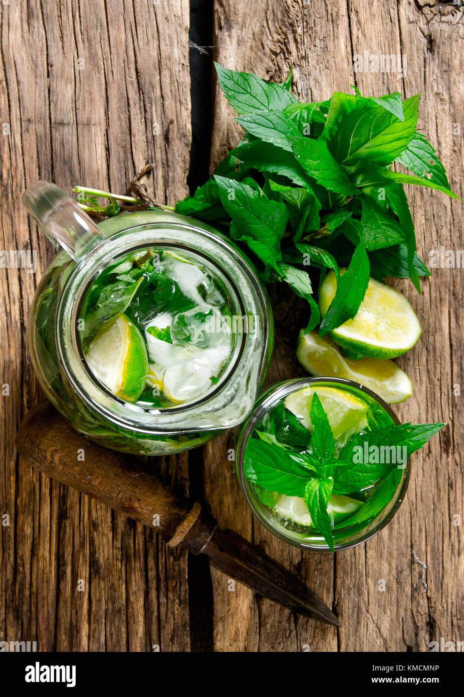 Mojito cocktail . Cooked cocktail of lime, mint, rum and ice on wooden ...