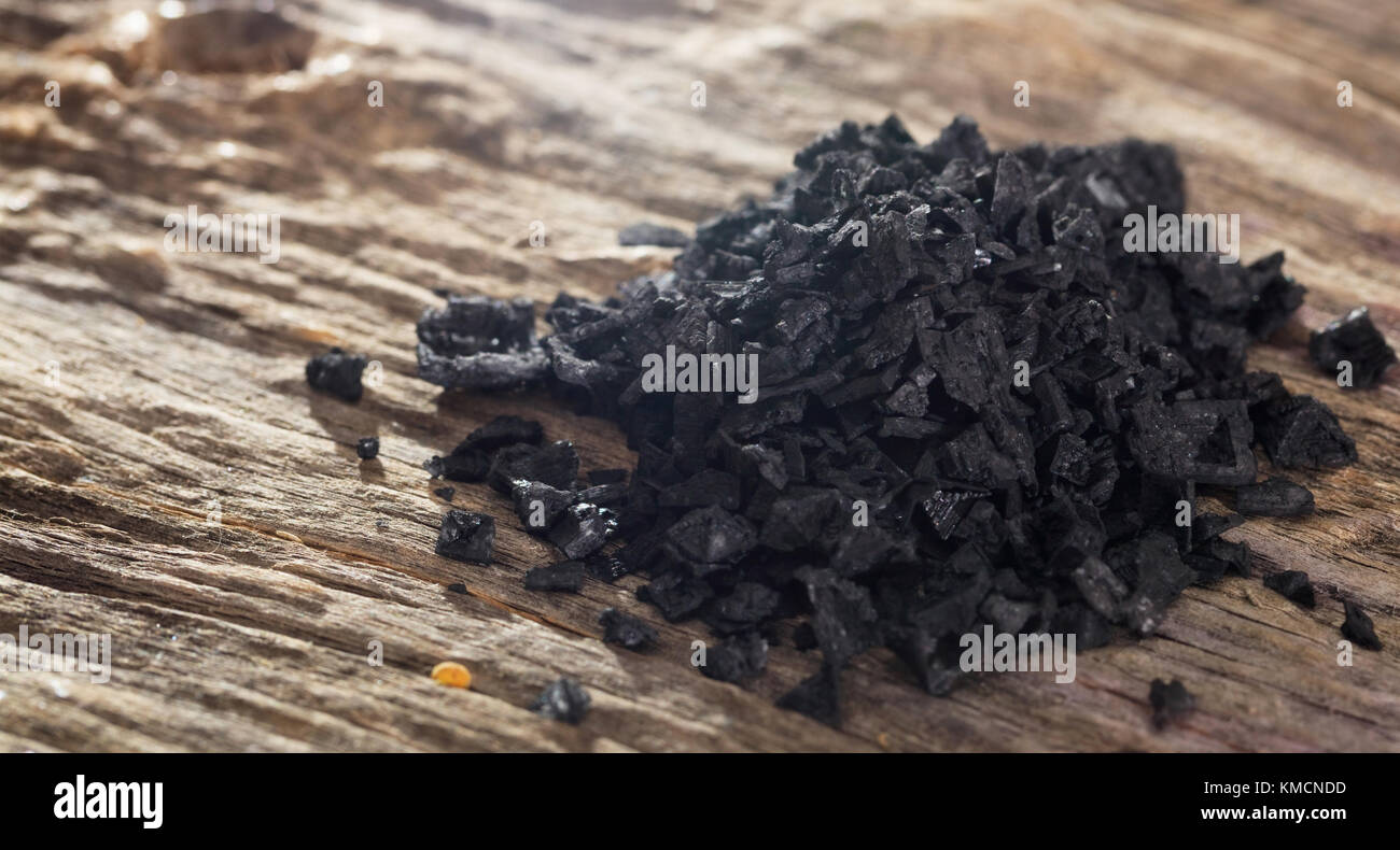 Pile of black lava salt on wooden table. Closeup view Stock Photo - Alamy