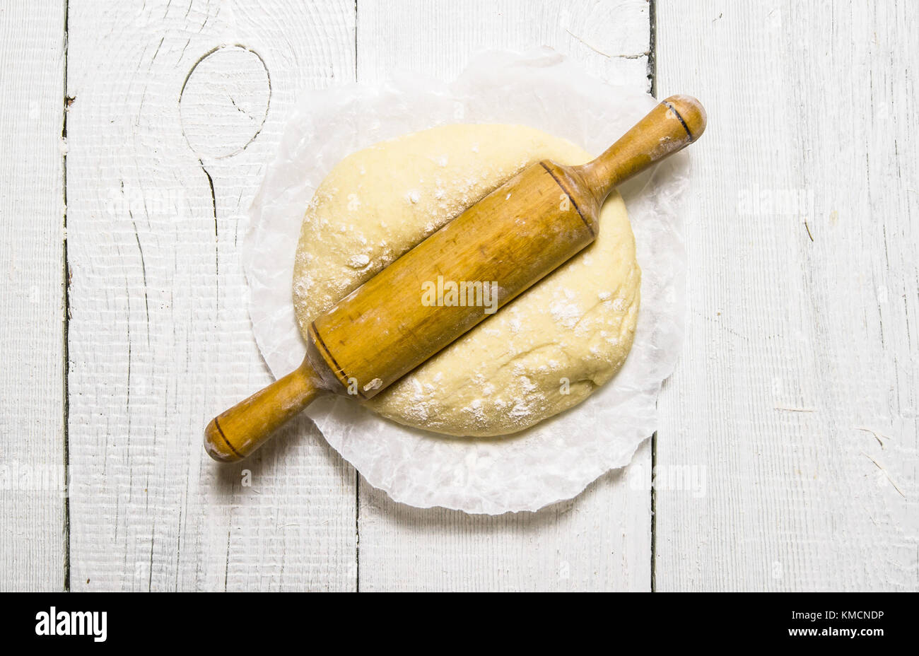 Preparation of the dough. The prepared dough with a rolling pin on ...