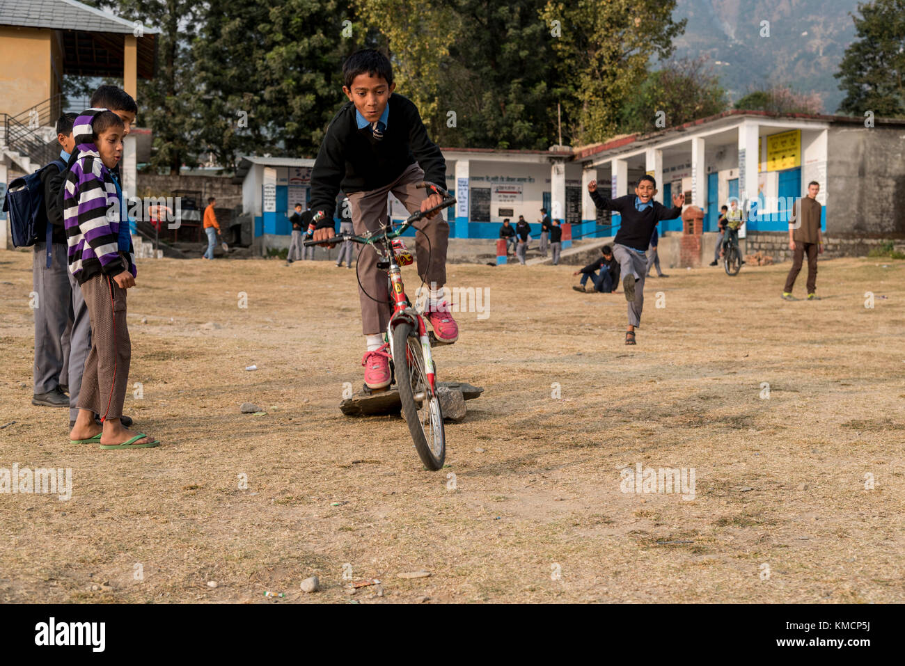 A young school boy cycling on a ground Stock Photo - Alamy