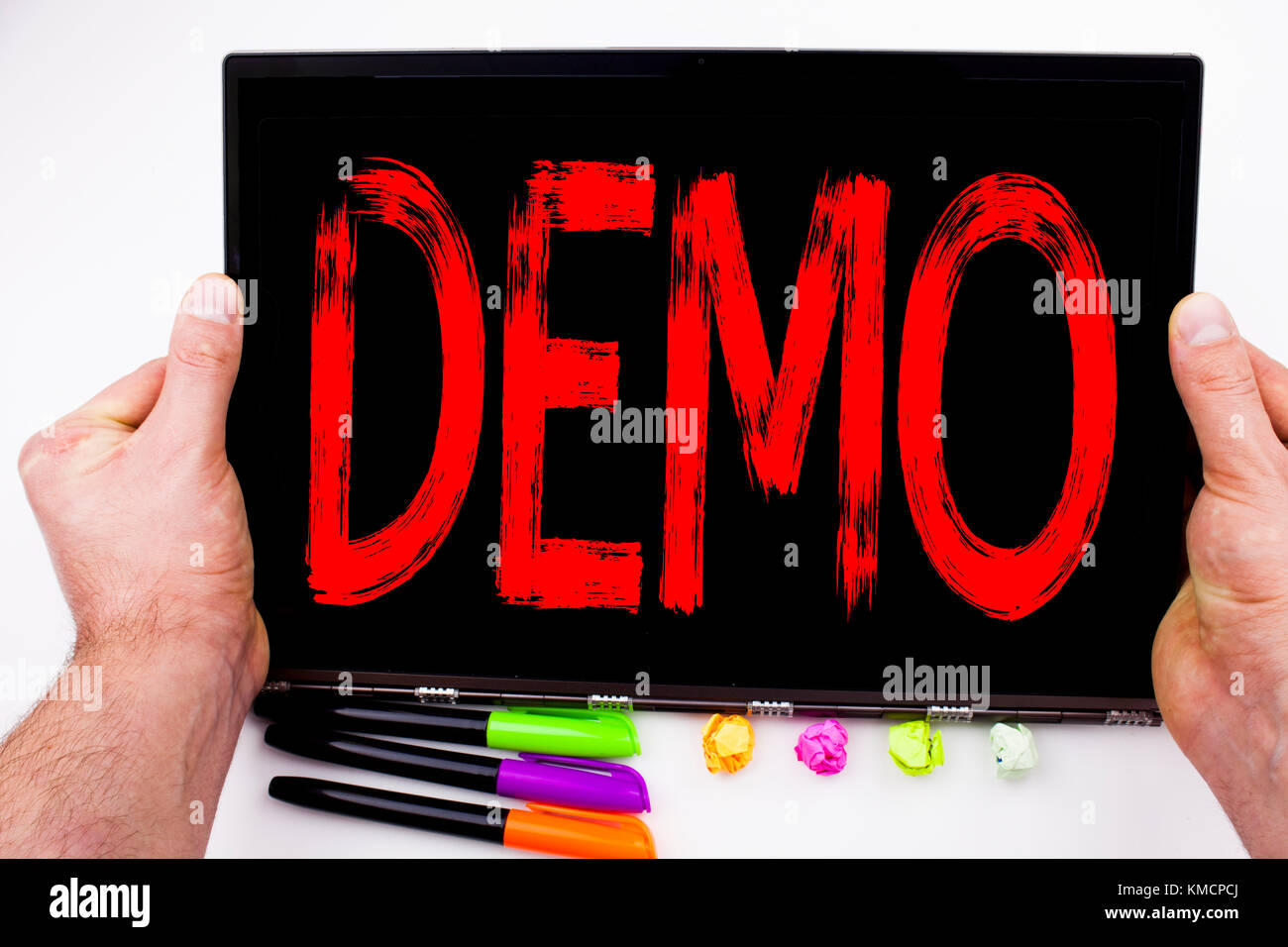Demo text written on tablet, computer in the office with marker, pen ...