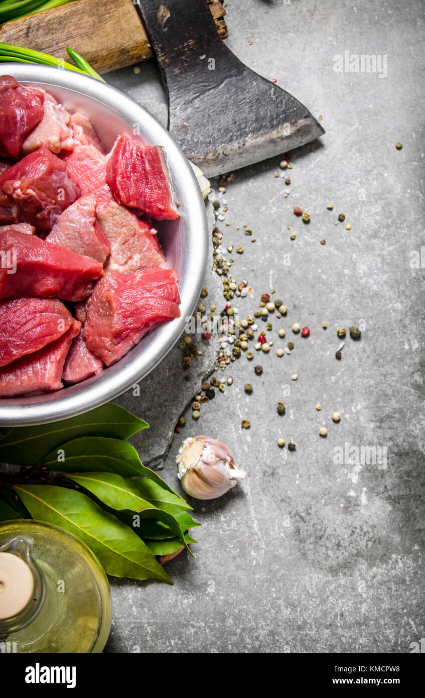 Fresh meat chopped with axe and spices. On the stone table Stock Photo ...