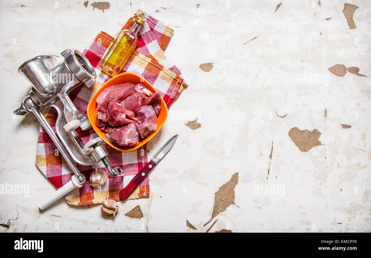 Processing of meat. Raw fresh meat with a meat grinder . On rustic ...