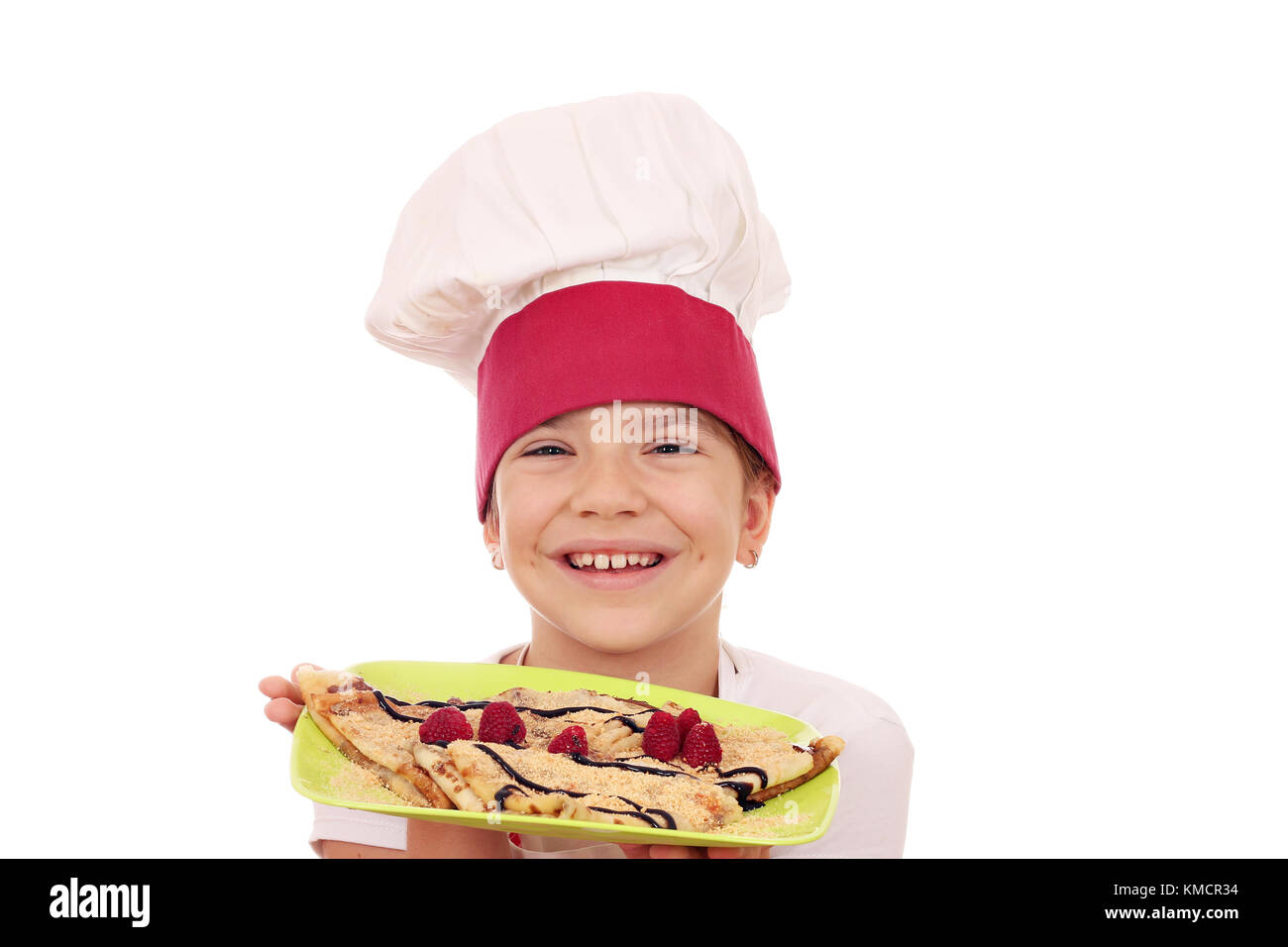 happy little girl cook with crepes on plate Stock Photo - Alamy