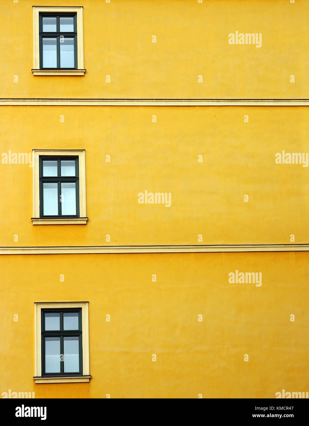 Yellow building wall with windows Stock Photo - Alamy