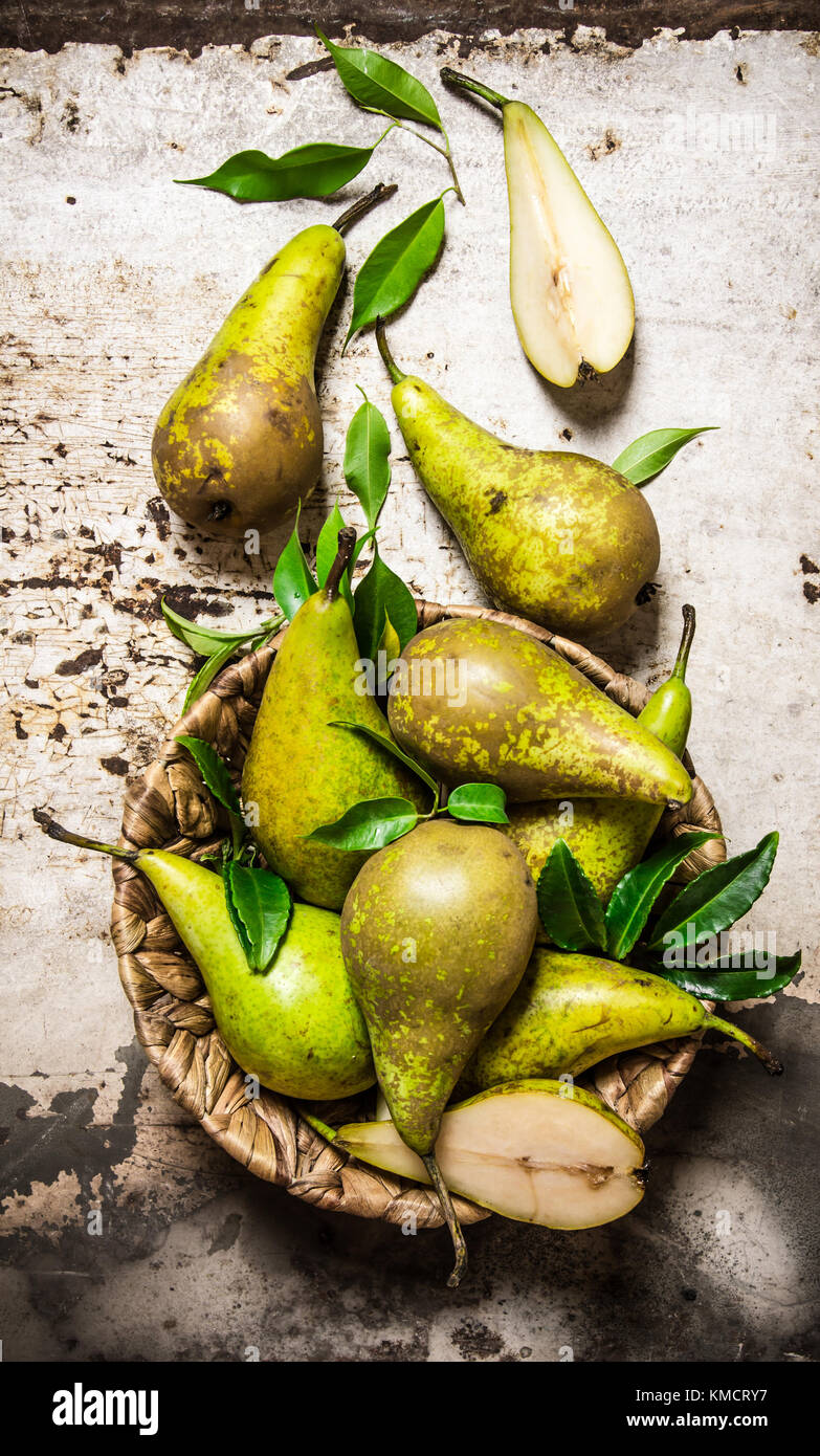 Pears in a basket with leaves. On rustic background. Top view Stock ...