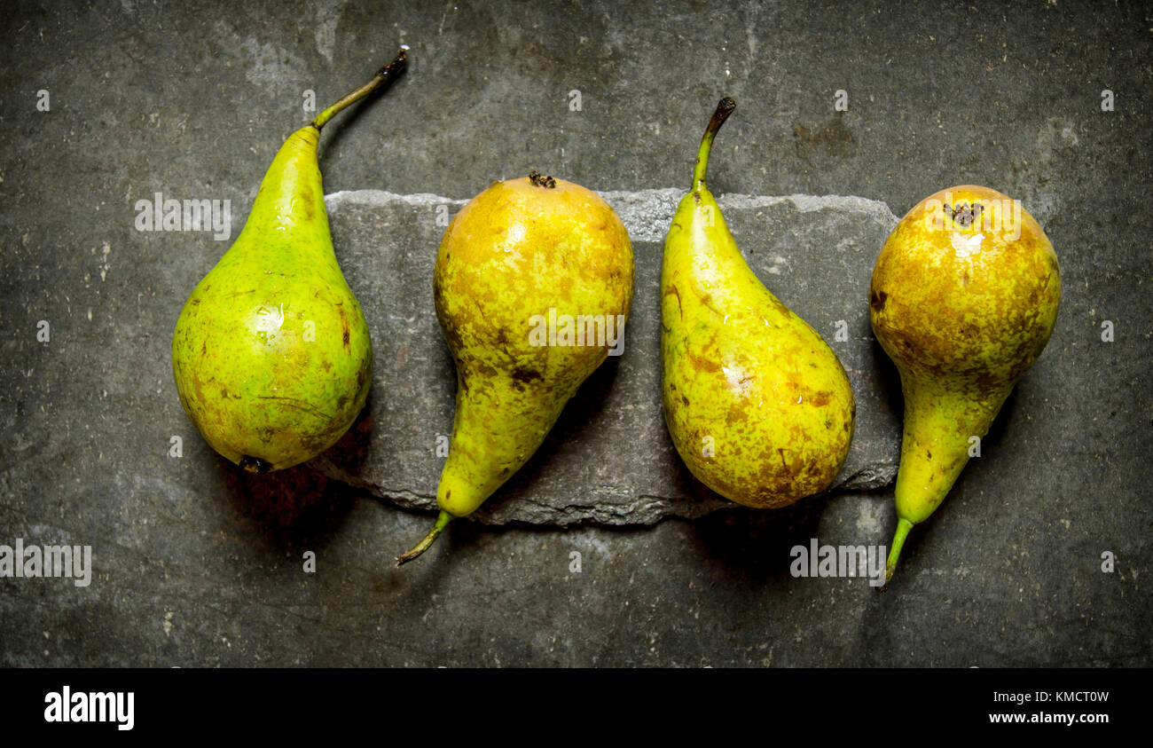 Fresh pears on a stone stand. On the stone table. Top view Stock Photo ...