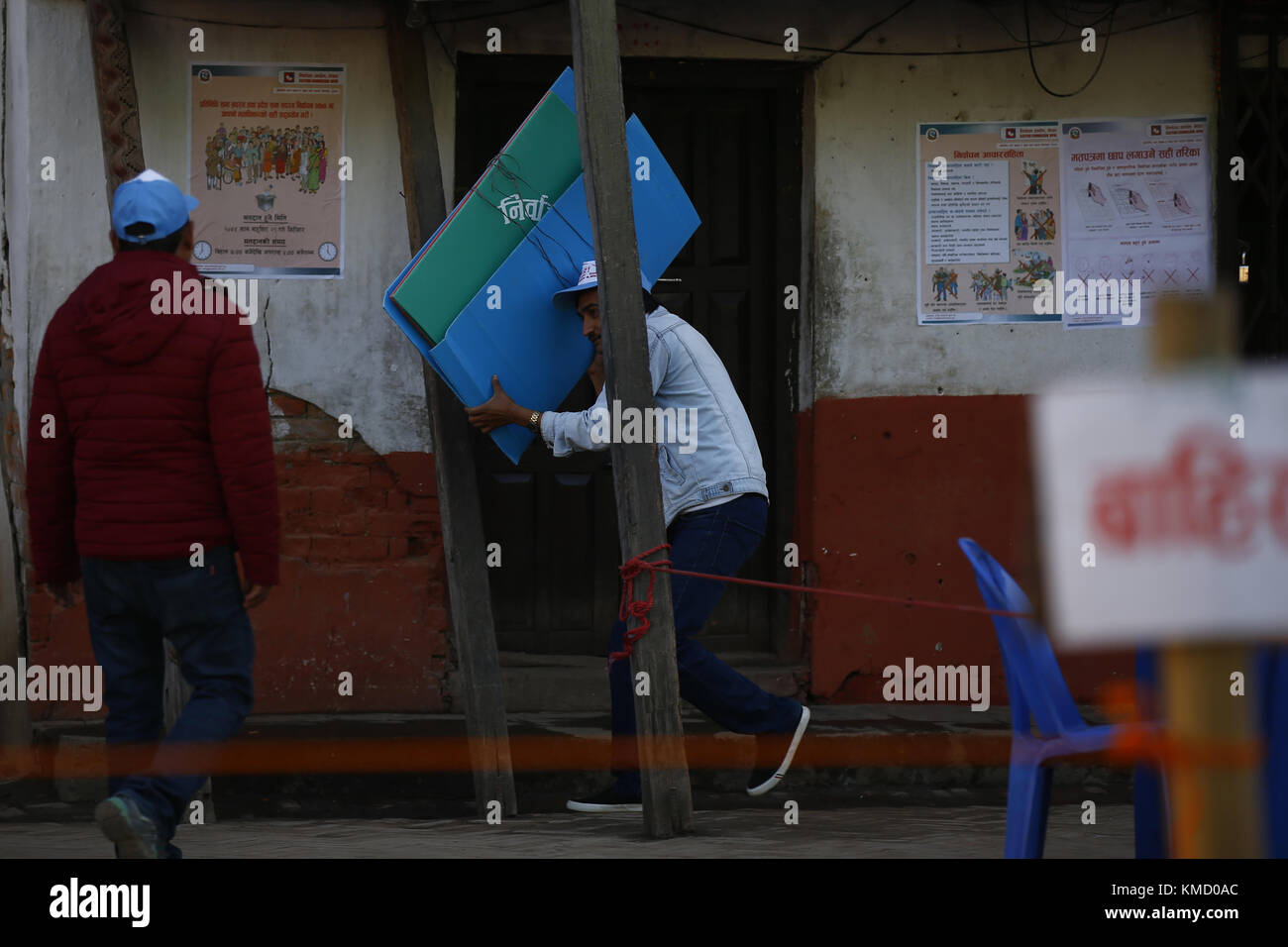 Kathmandu, Nepal. 6th Dec, 2017. An Election Commission staff carries ...
