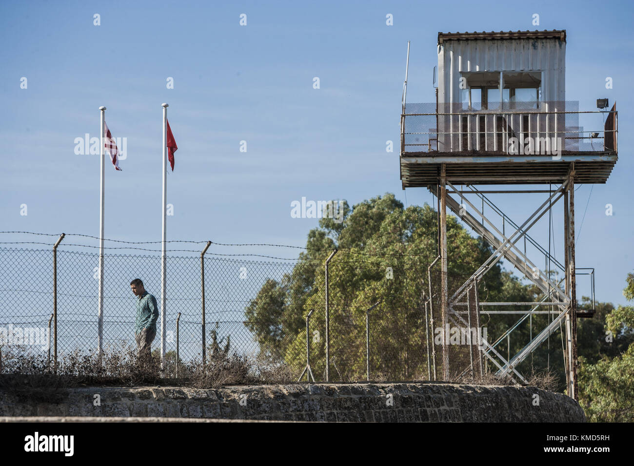A man takes a walk under a watchtower of the U.N. in the northern ...