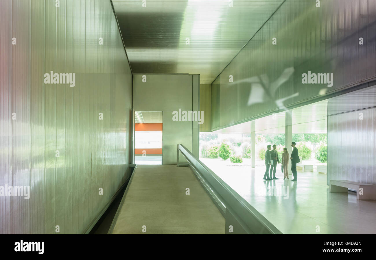 Business people talking in modern office lobby corridor Stock Photo - Alamy