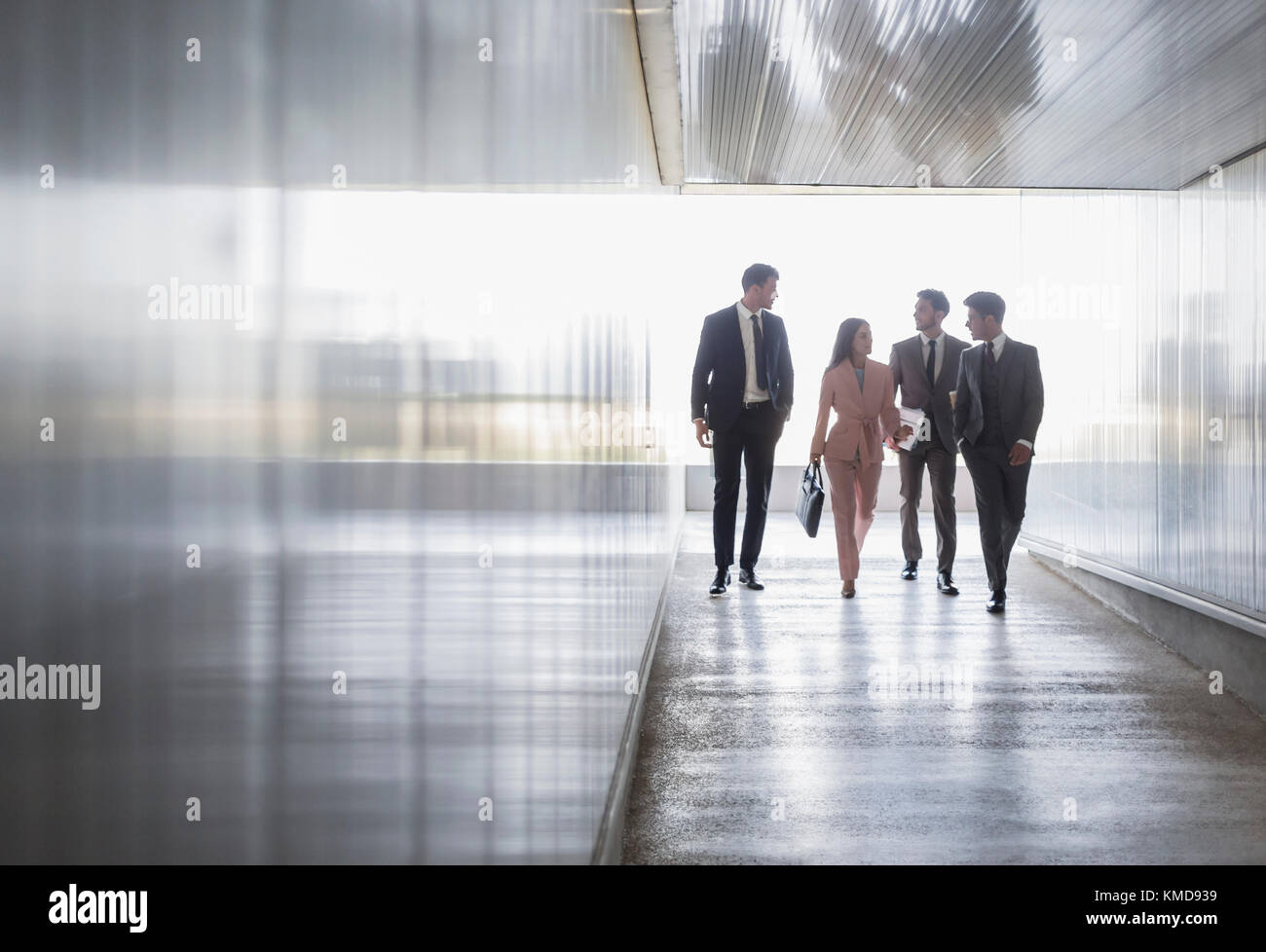 Business people walking and talking in office corridor Stock Photo - Alamy