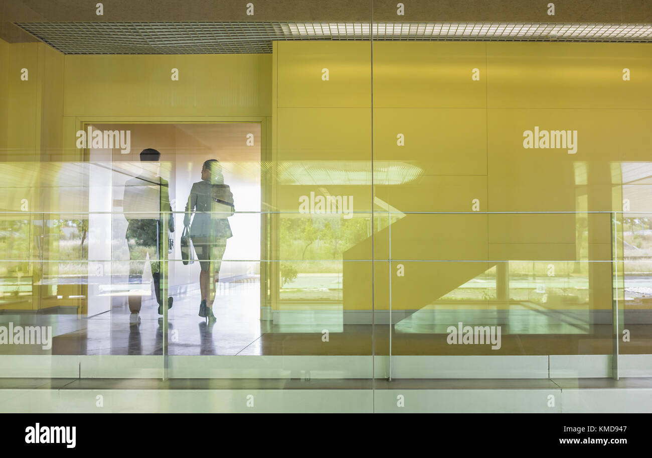 Business people walking in modern office corridor Stock Photo - Alamy
