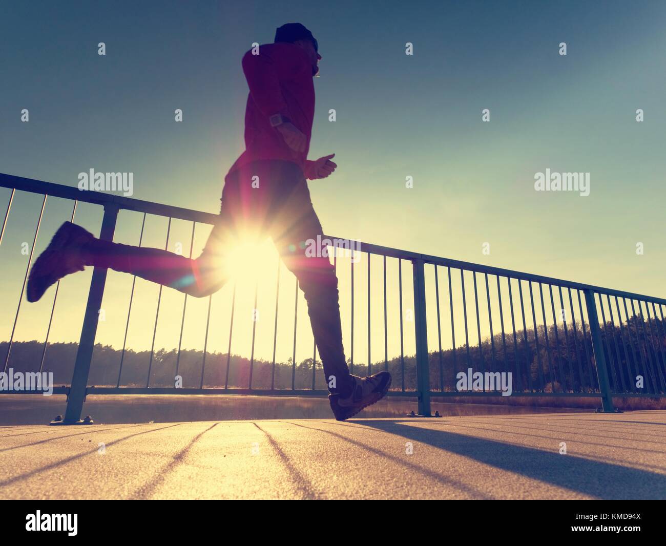 Morning runner in tall black leggings exercising on bridge. Outdoor ...