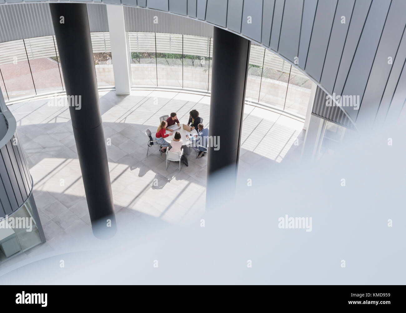 Business people meeting at table in modern office atrium Stock Photo ...