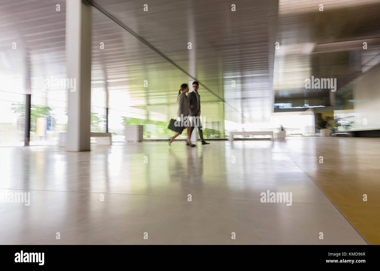 Business people walking in modern office corridor Stock Photo - Alamy
