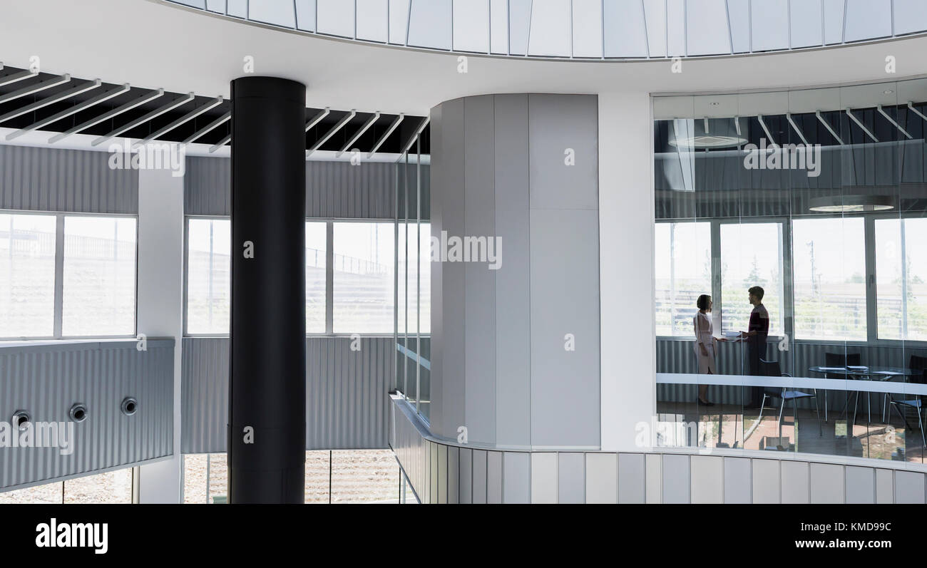 Business people talking in architectural,modern office conference room ...