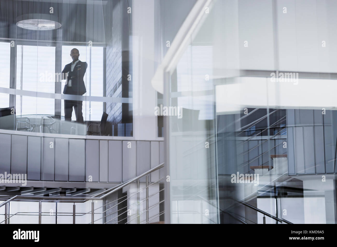 Confident CEO businessman standing with arms crossed at modern office ...