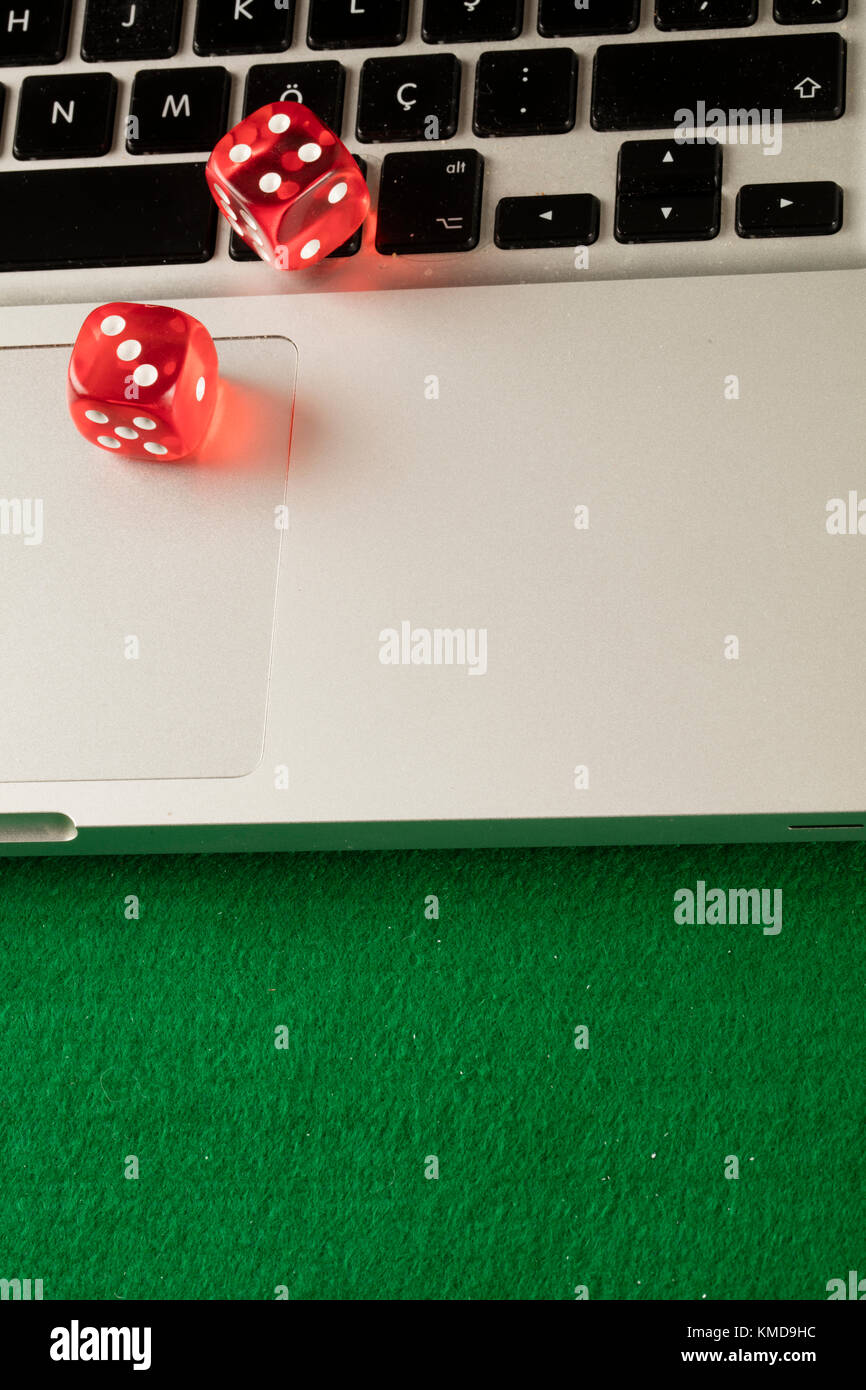 red color dice on keyboard close up Stock Photo - Alamy