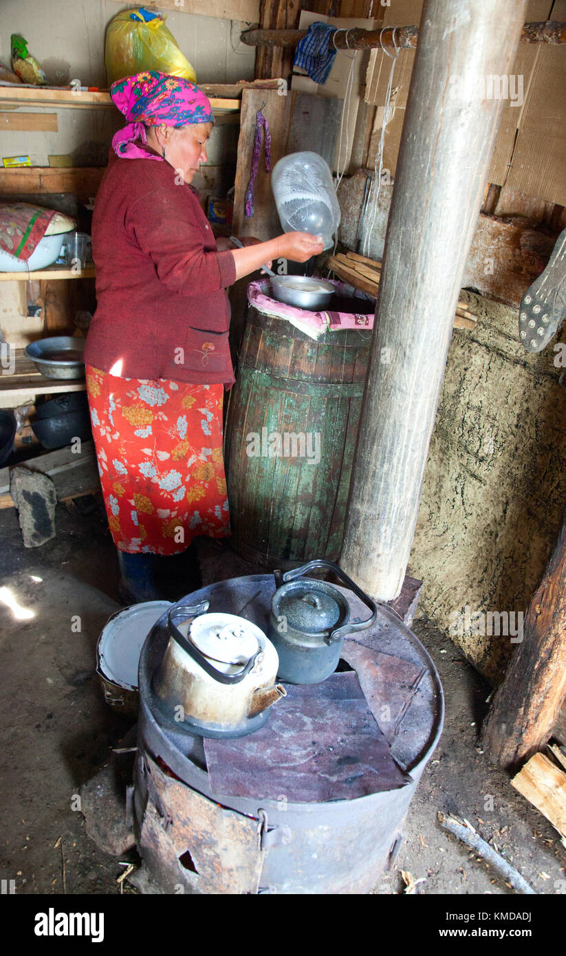 The woman at the camp prepares koumiss in the traditional way Stock ...