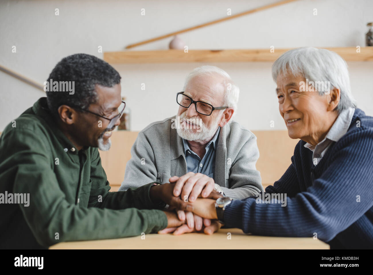 senior friends making team gesture Stock Photo - Alamy