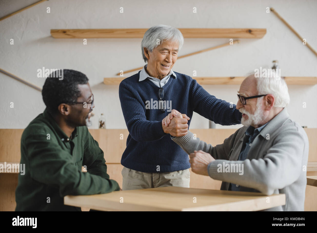 senior friends greeting in cafe Stock Photo - Alamy