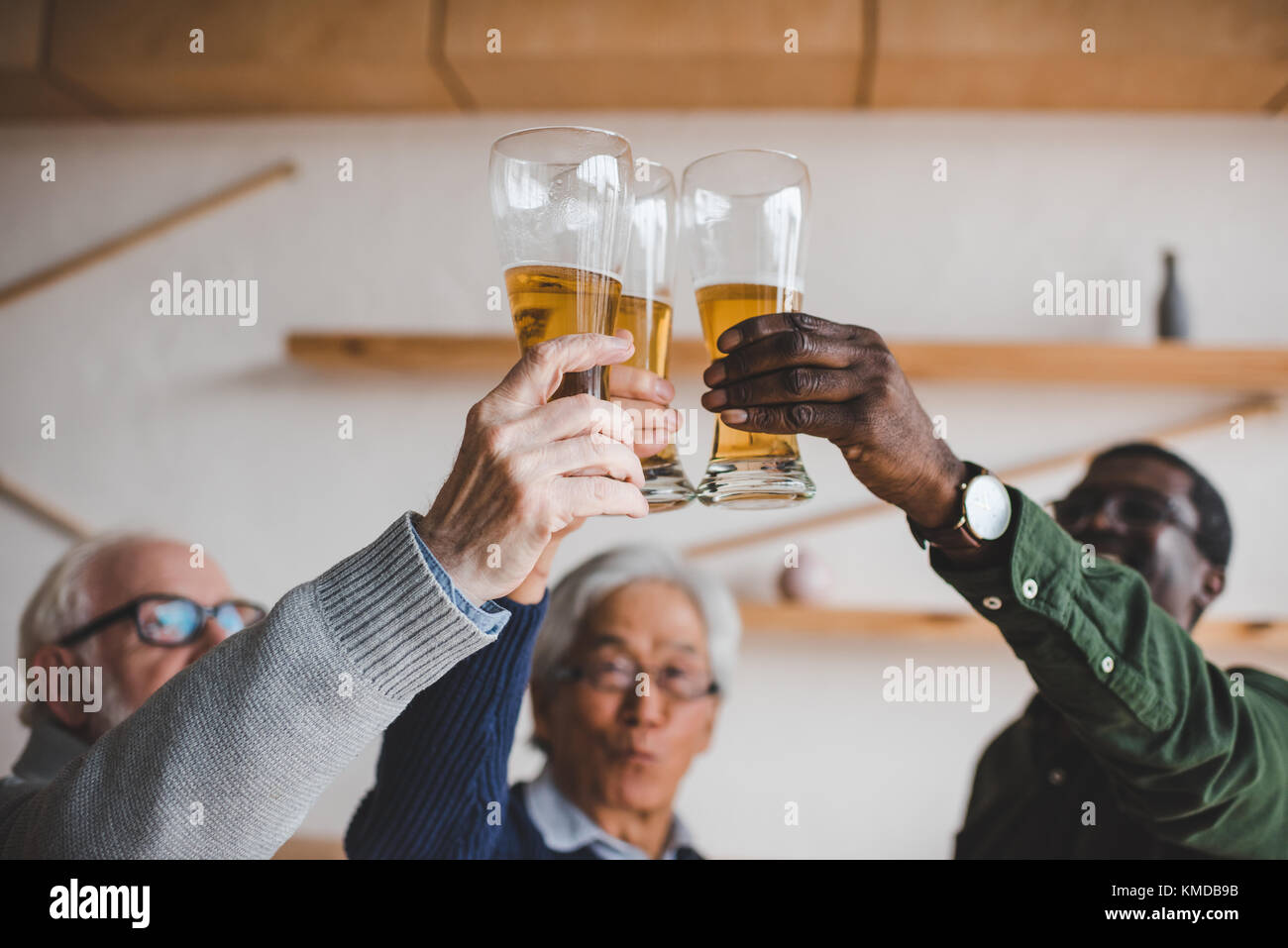 senior friends clinking glasses of beer Stock Photo - Alamy