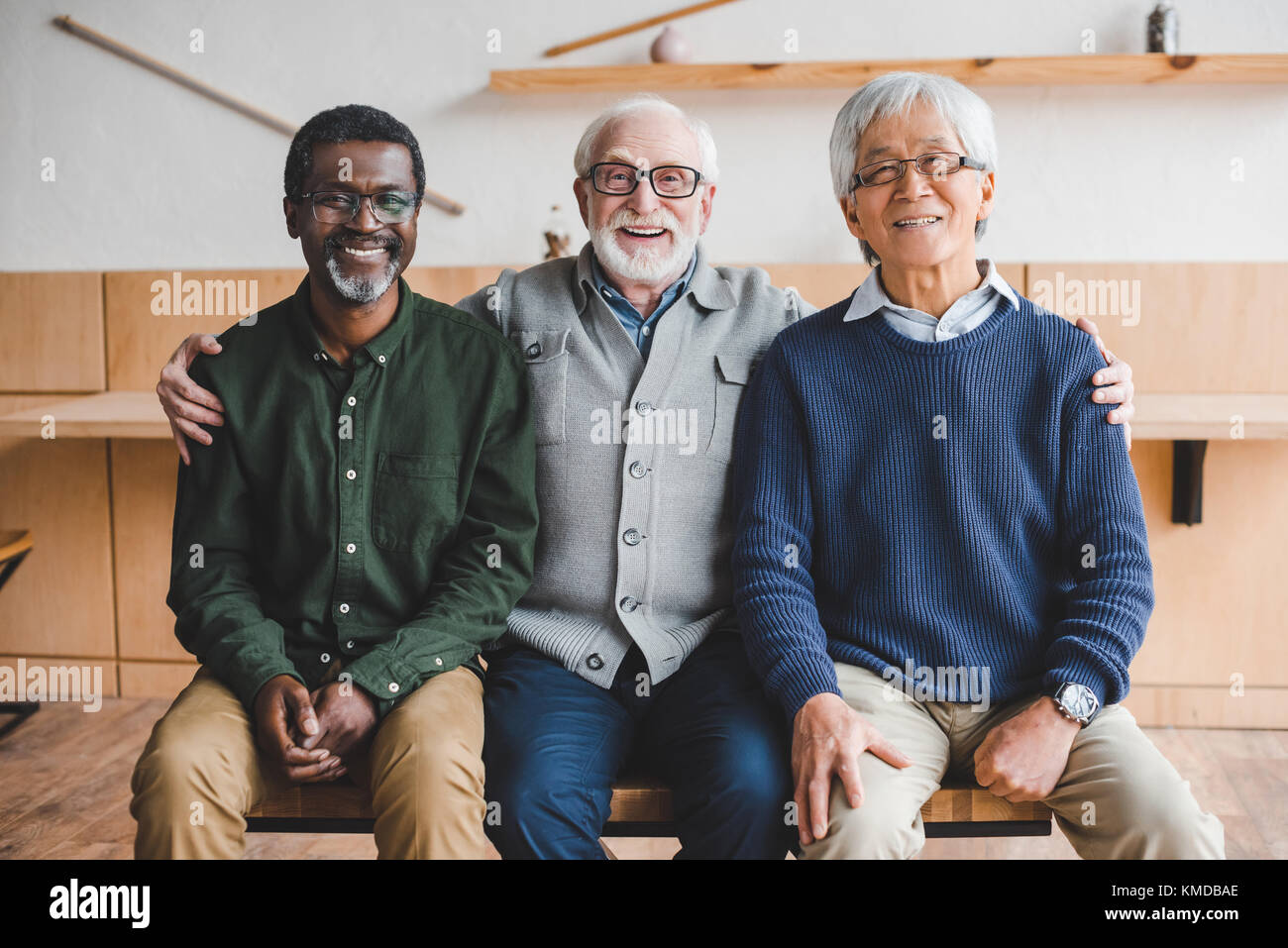 embracing senior friends Stock Photo - Alamy